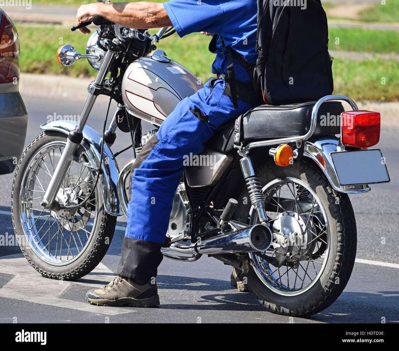 Man with a motorcycle on the street in the city Stock Photo - Alamy