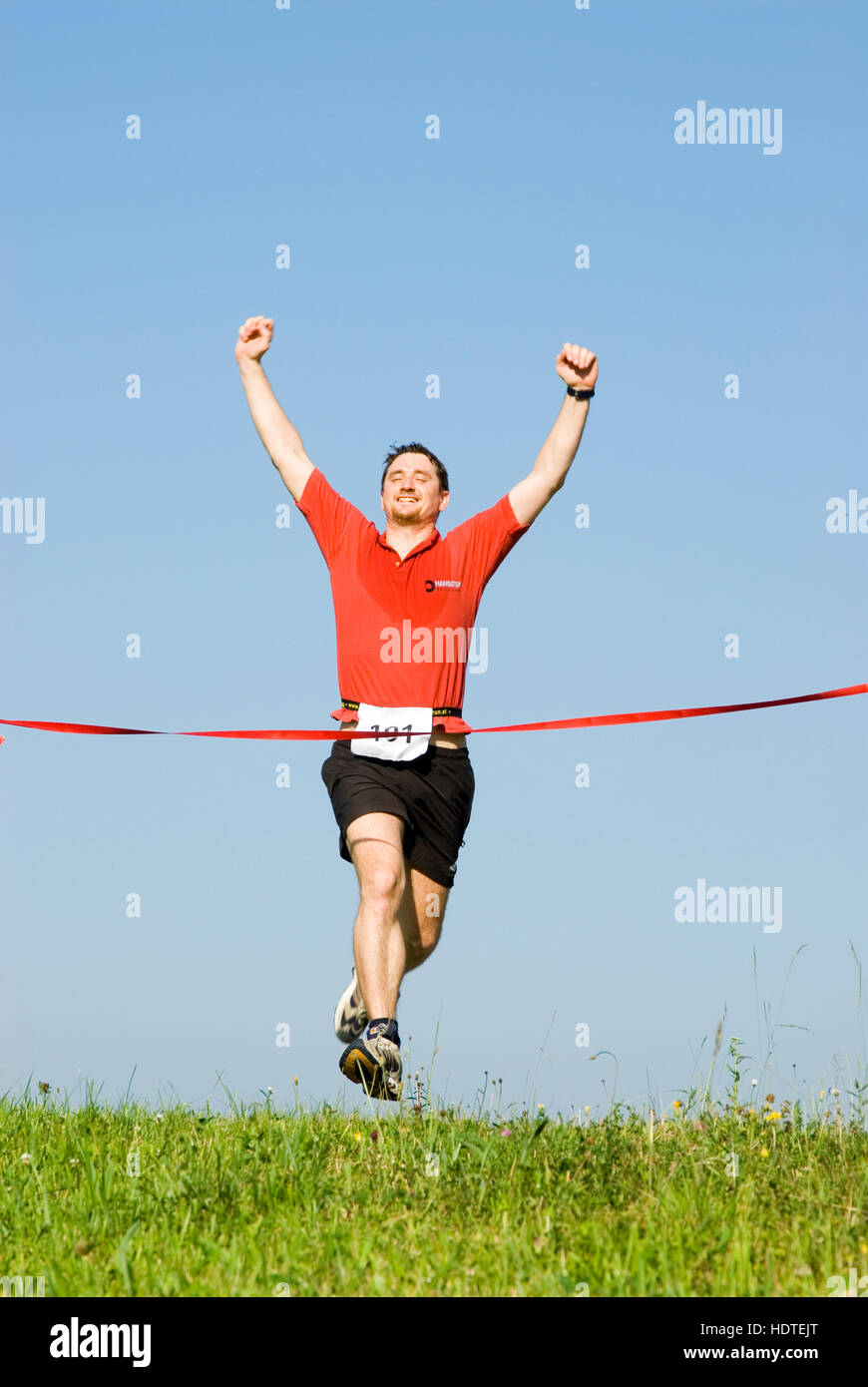 Man crossing the finish line Stock Photo - Alamy