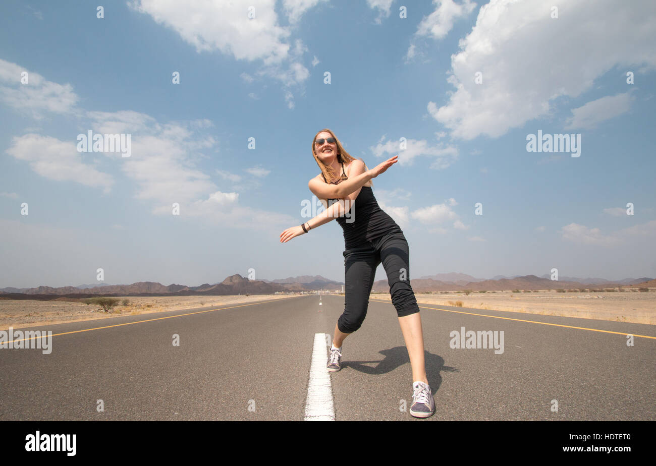 Young woman jumping on a road Stock Photo - Alamy