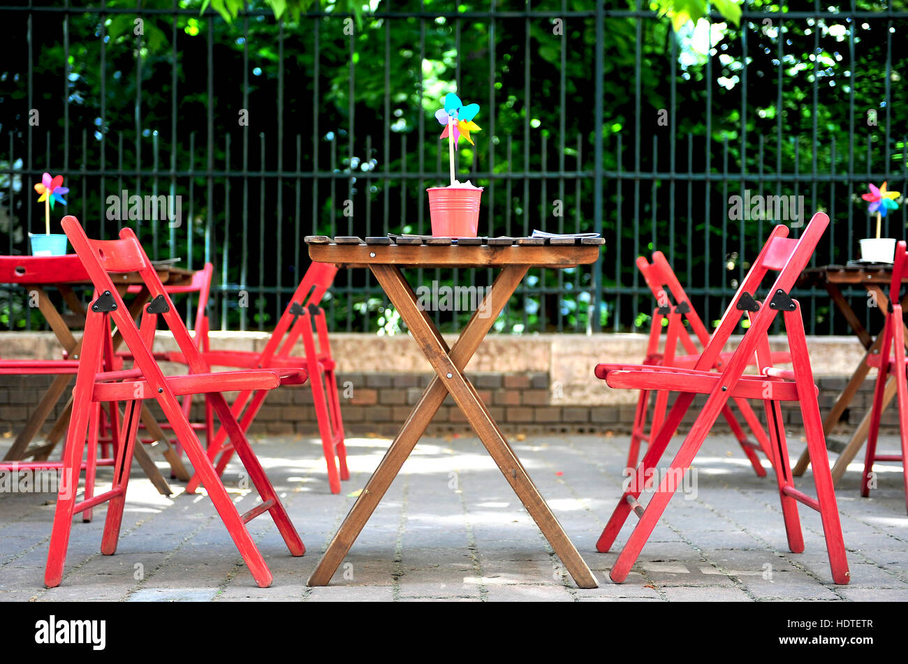Colorful wooden cafe tables and chairs Stock Photo - Alamy
