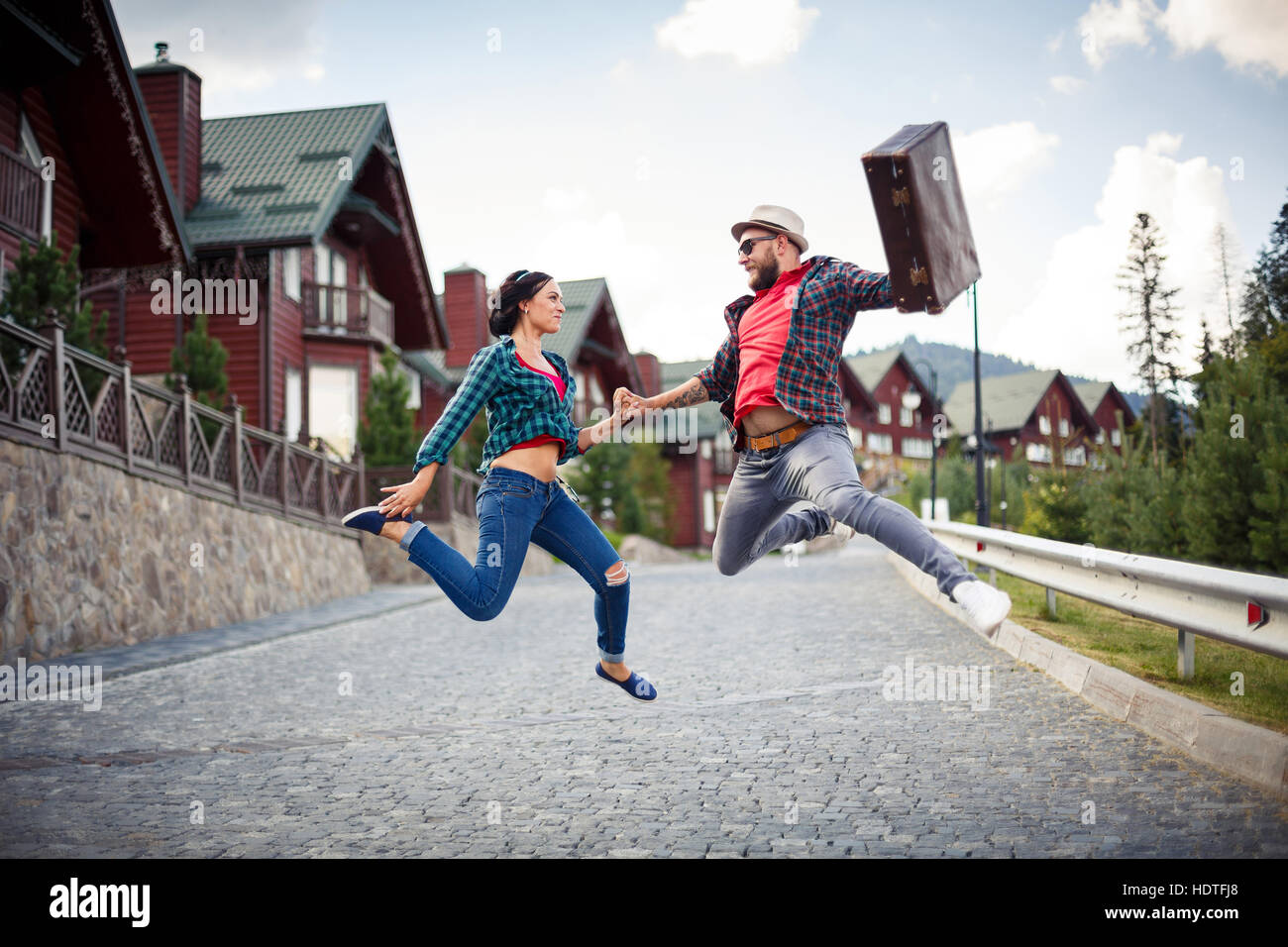 fun loving couple together jumping the streets Stock Photo - Alamy