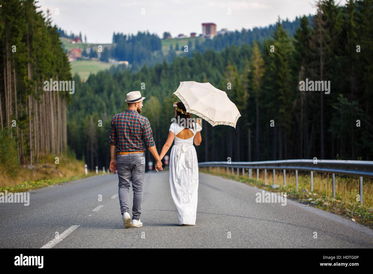 loving couple walking along the road in the forest Stock Photo - Alamy