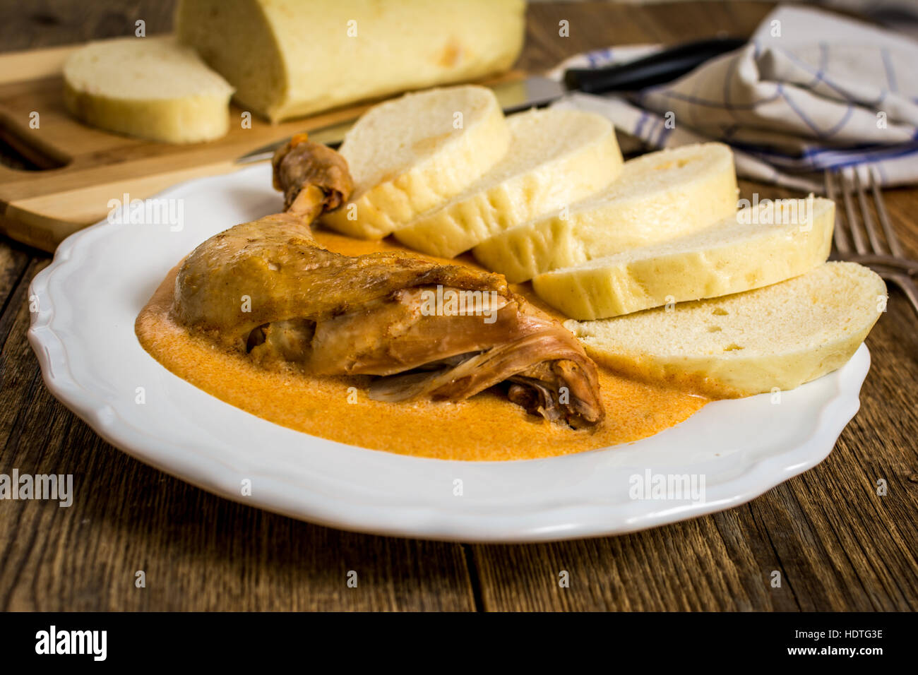 Traditional Czech cuisine chicken thigh on red pepper with dumplings ...