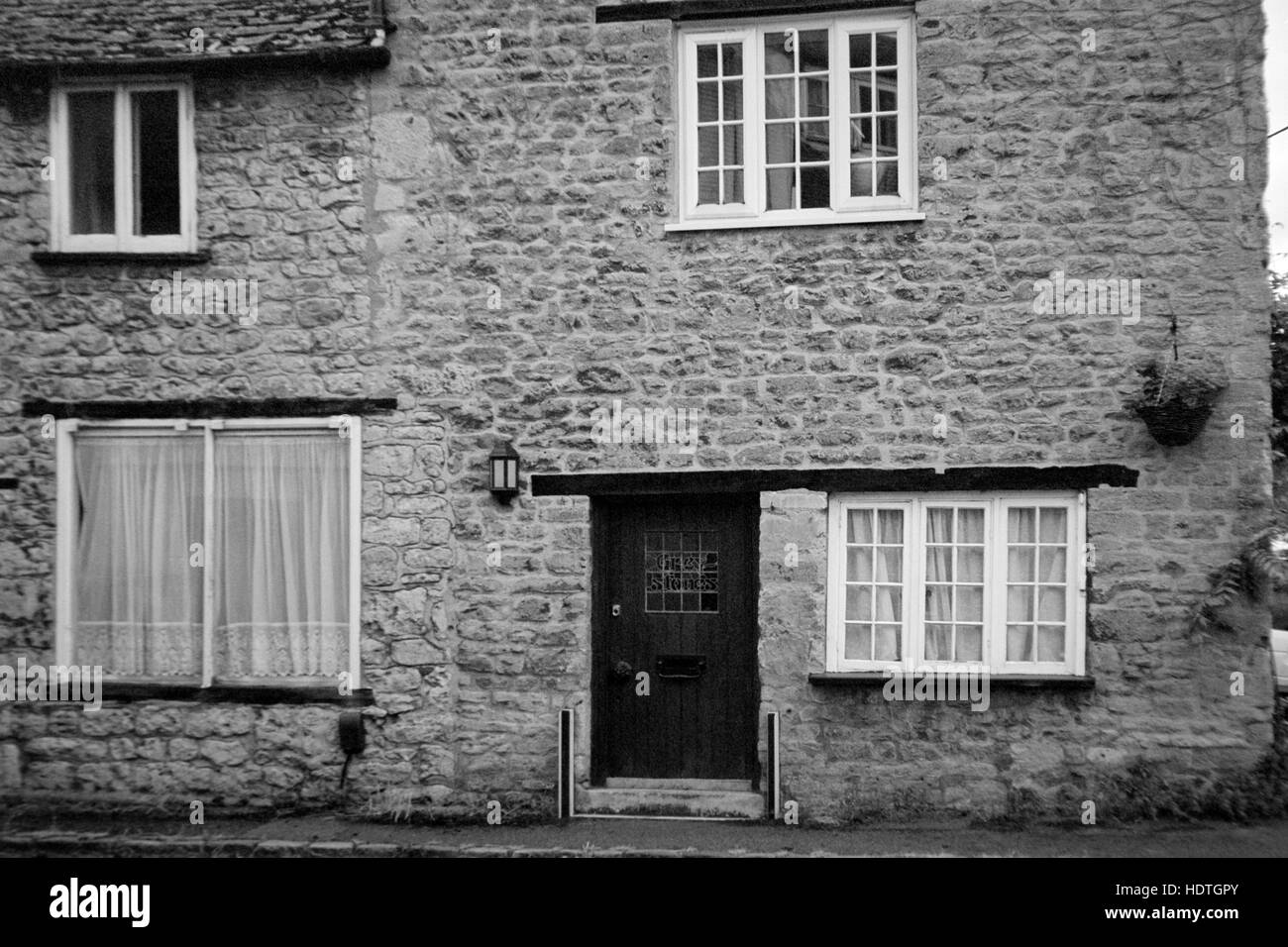 exterior of a traditional stone built house with crooked windows ...