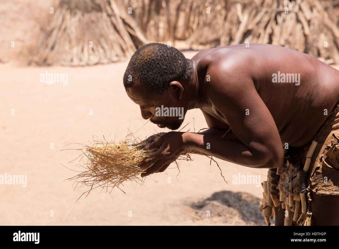 Damara tribesman demonstrating traditional fire lighting in Namibia ...