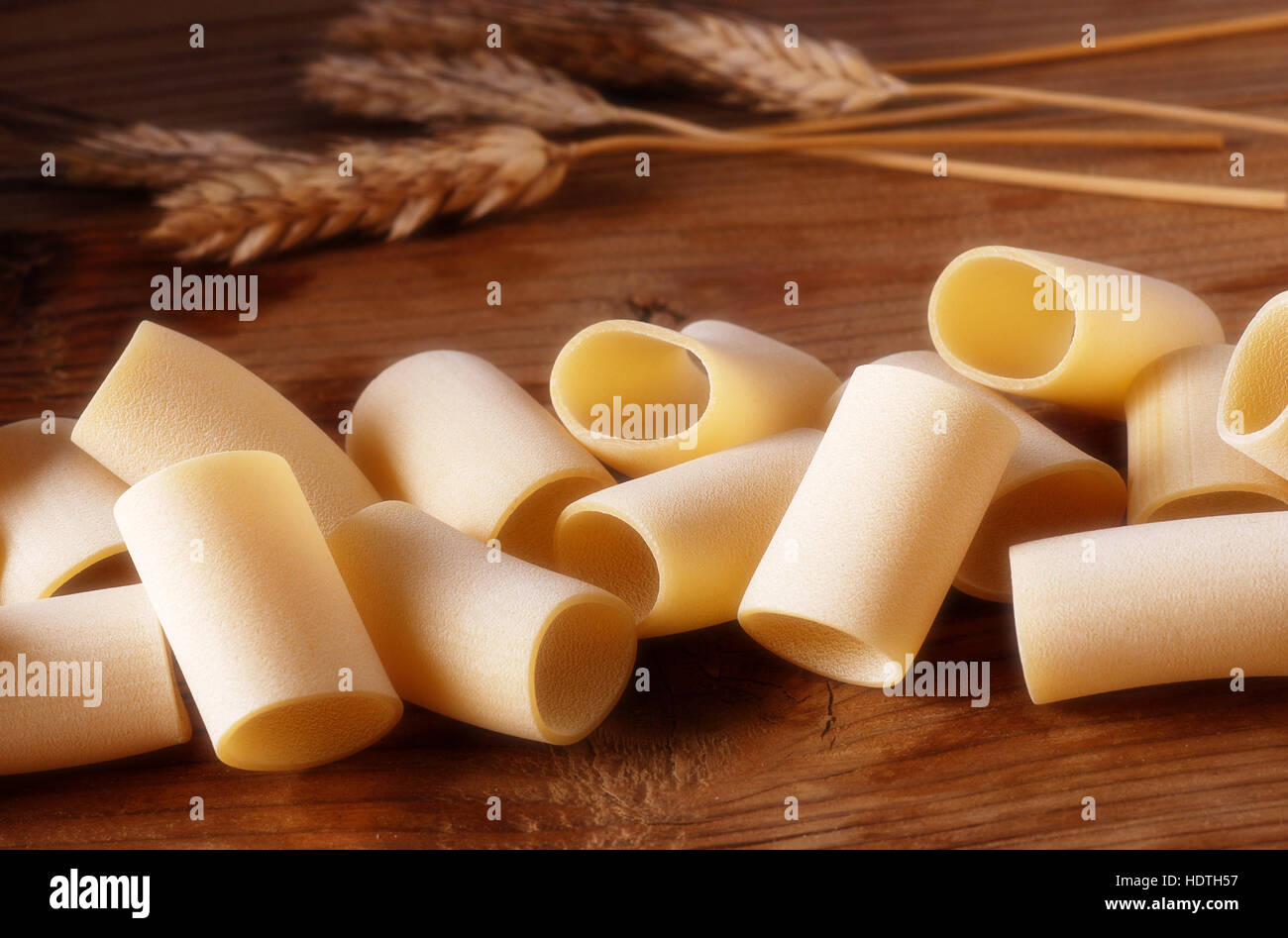 Paccheri raw on the wooden table, traditional Neapolitan pasta Stock ...