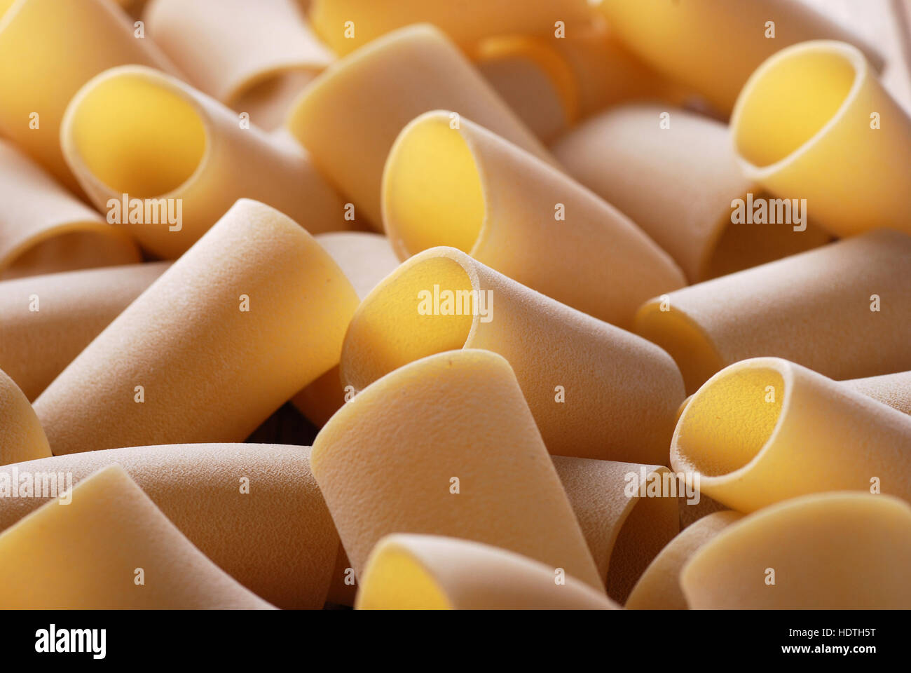 Paccheri raw on the wooden table, traditional Neapolitan pasta Stock ...