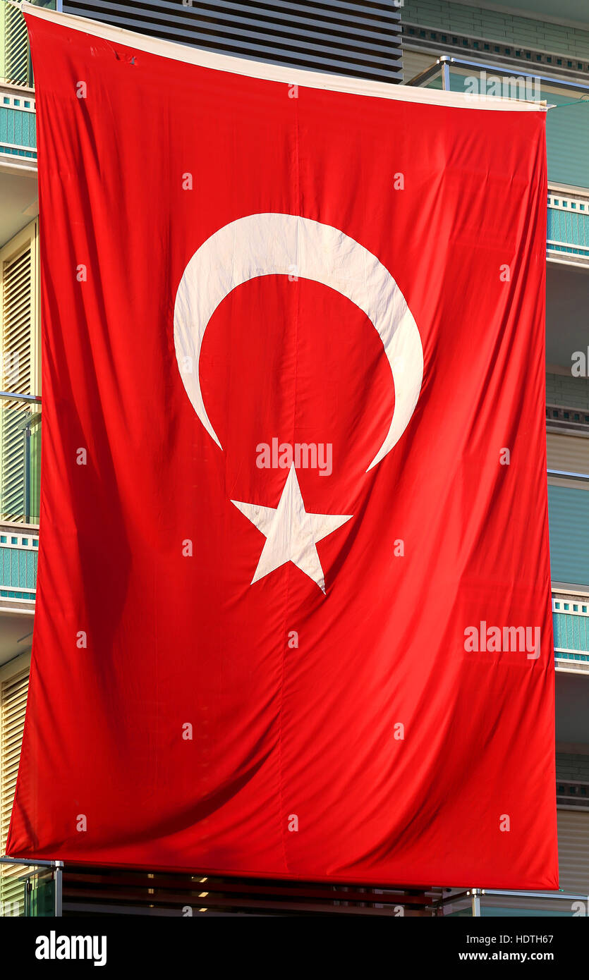 Photo of a bright red Turkish flag on the house Stock Photo - Alamy