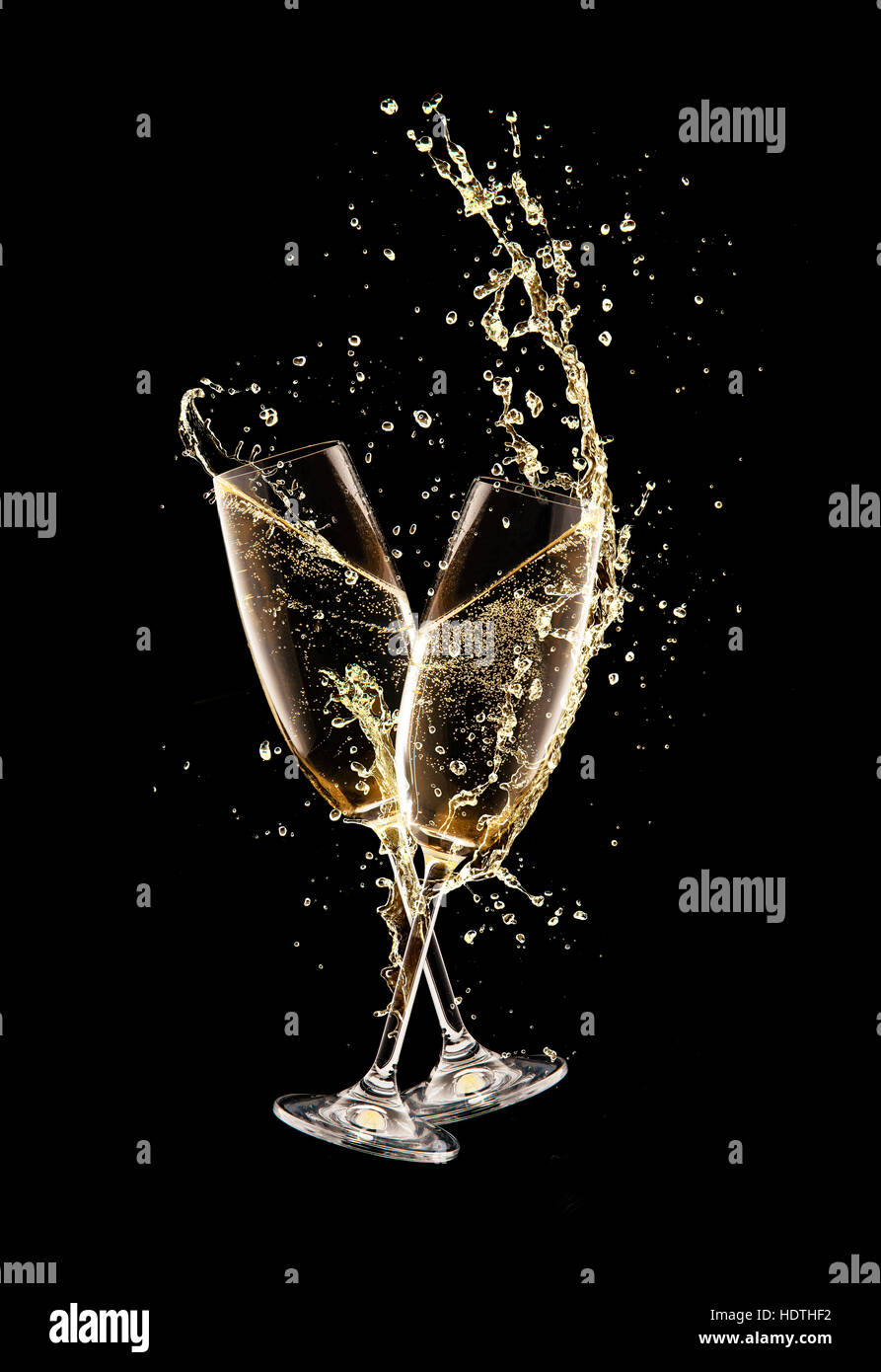 Two Glasses Of Champagne With Splash Over Black Background Celebration