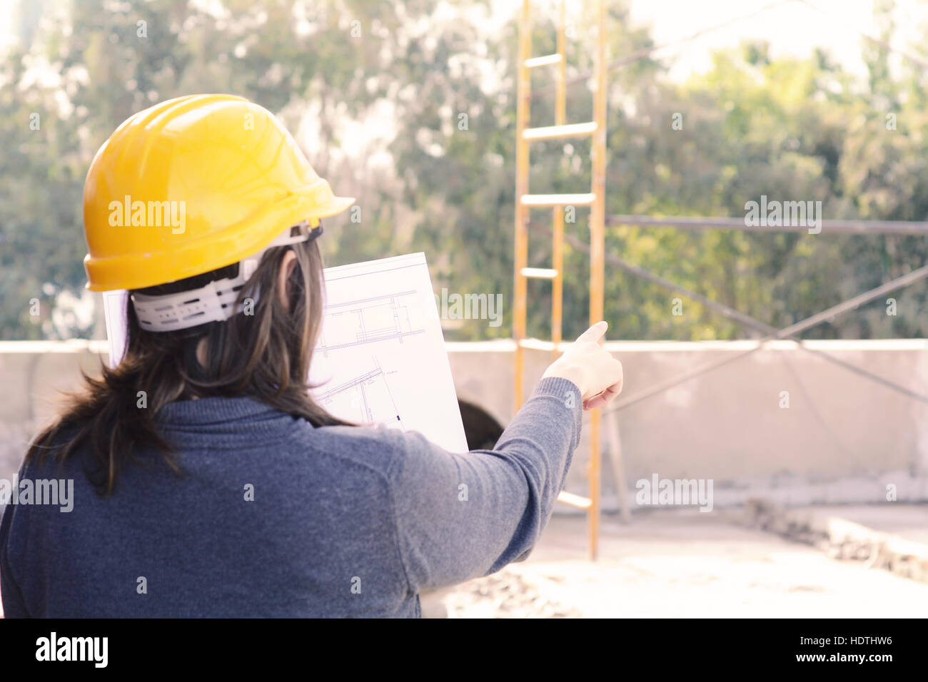 Portrait of a beautiful female architect at a construction site with ...