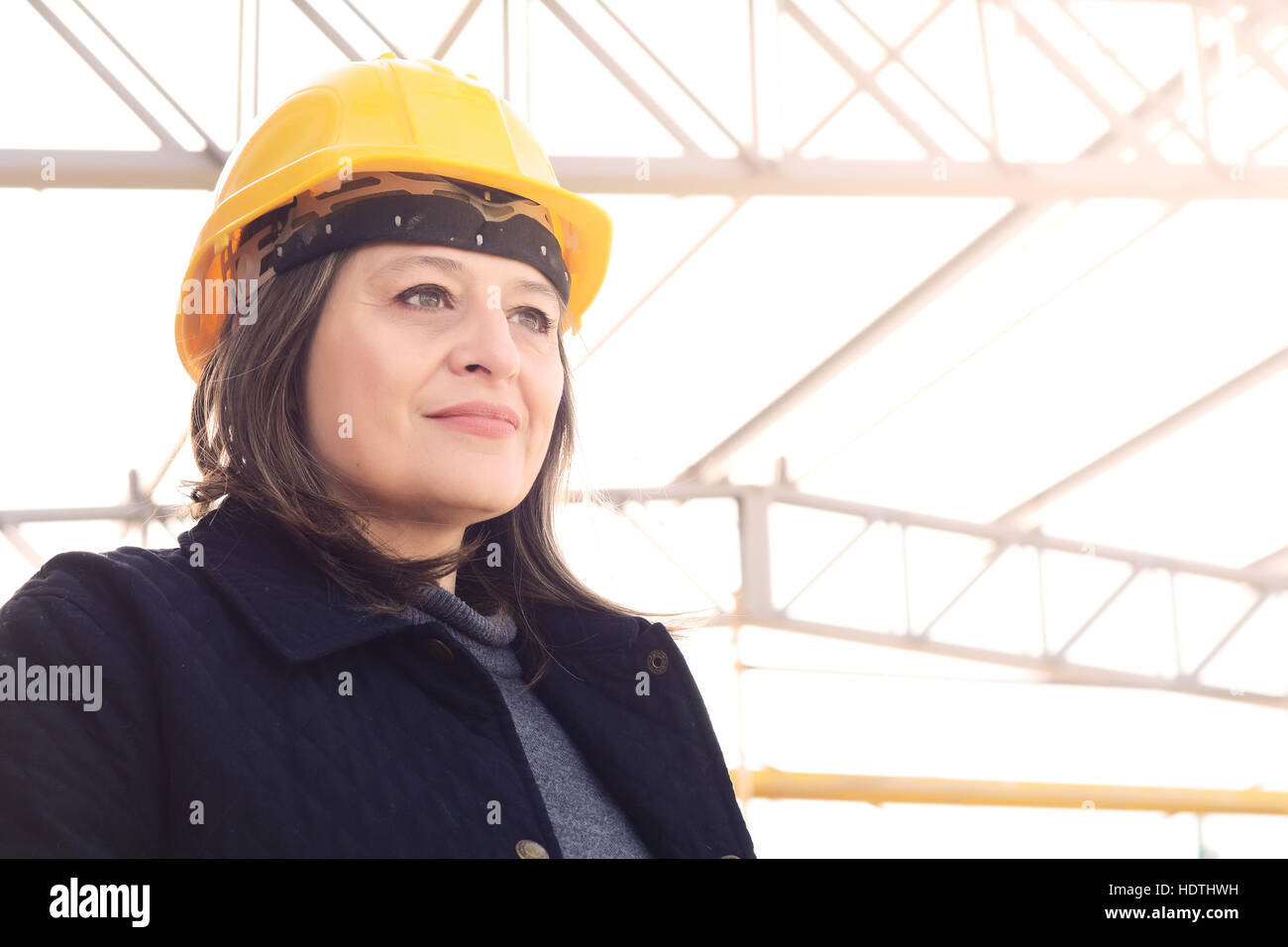 Close up of a beautiful female architect at a construction site ...