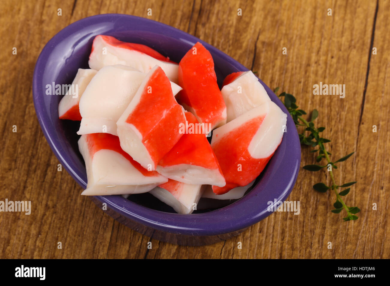 Crab stick - surimi in the plate - over wood background Stock Photo - Alamy