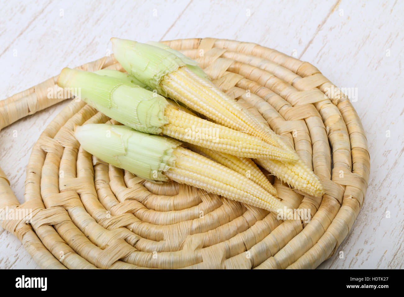 Fresh baby corn heap on the wood background Stock Photo - Alamy