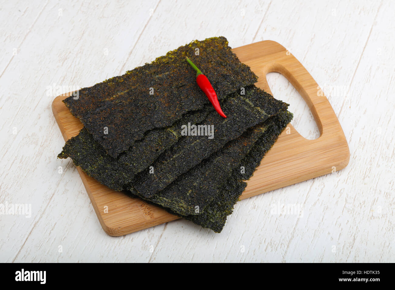 Spicy Nori seaweed sheets with pepper on wood Stock Photo - Alamy