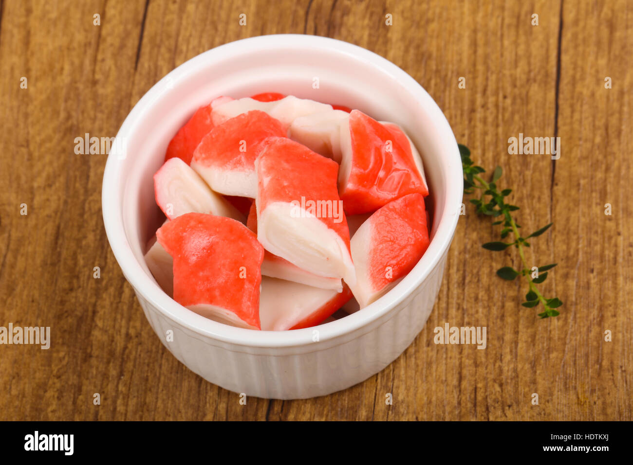 Crab stick - surimi in the plate - over wood background Stock Photo - Alamy