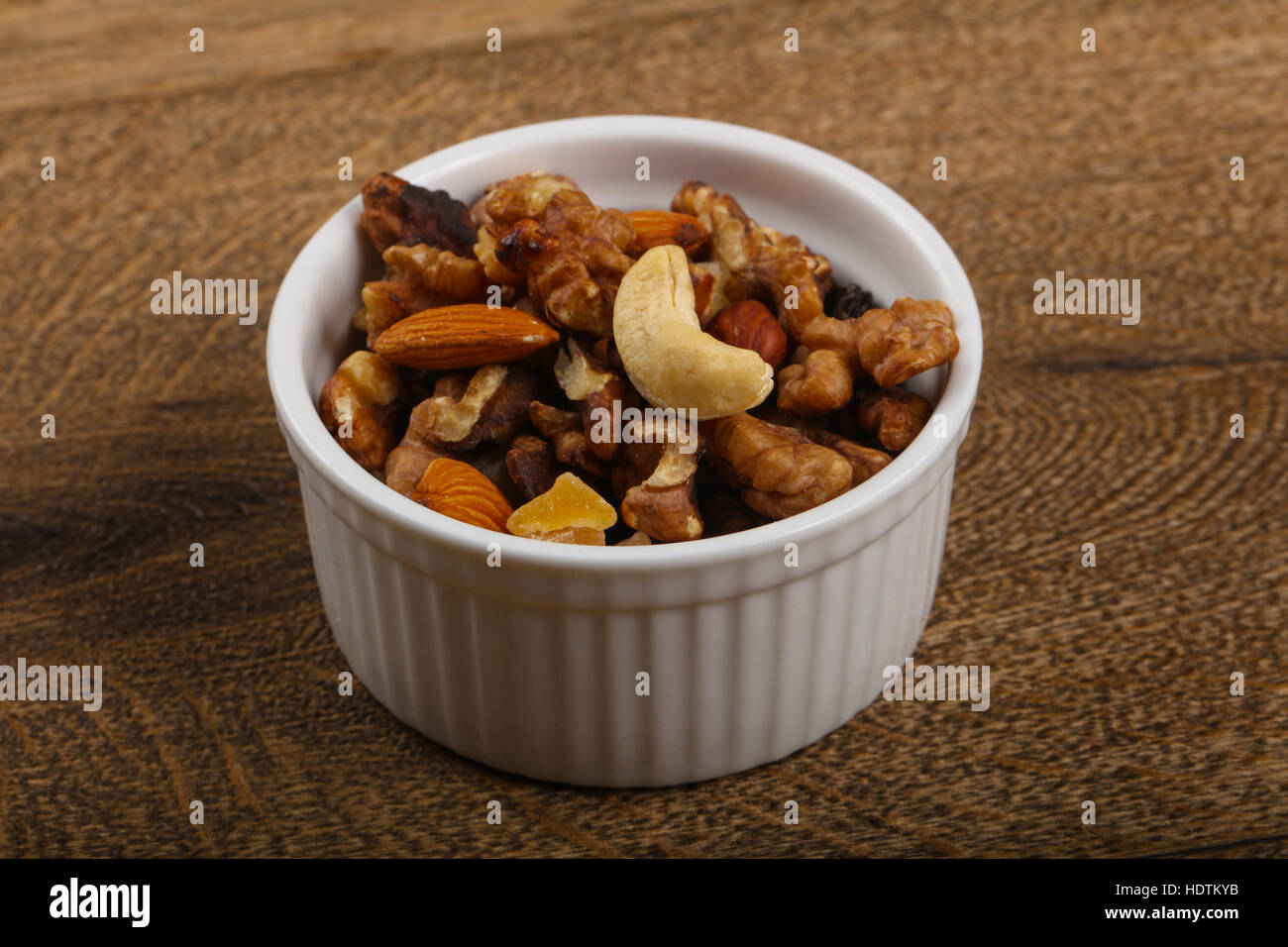 Nut mix heap in the bowl over wood background Stock Photo - Alamy