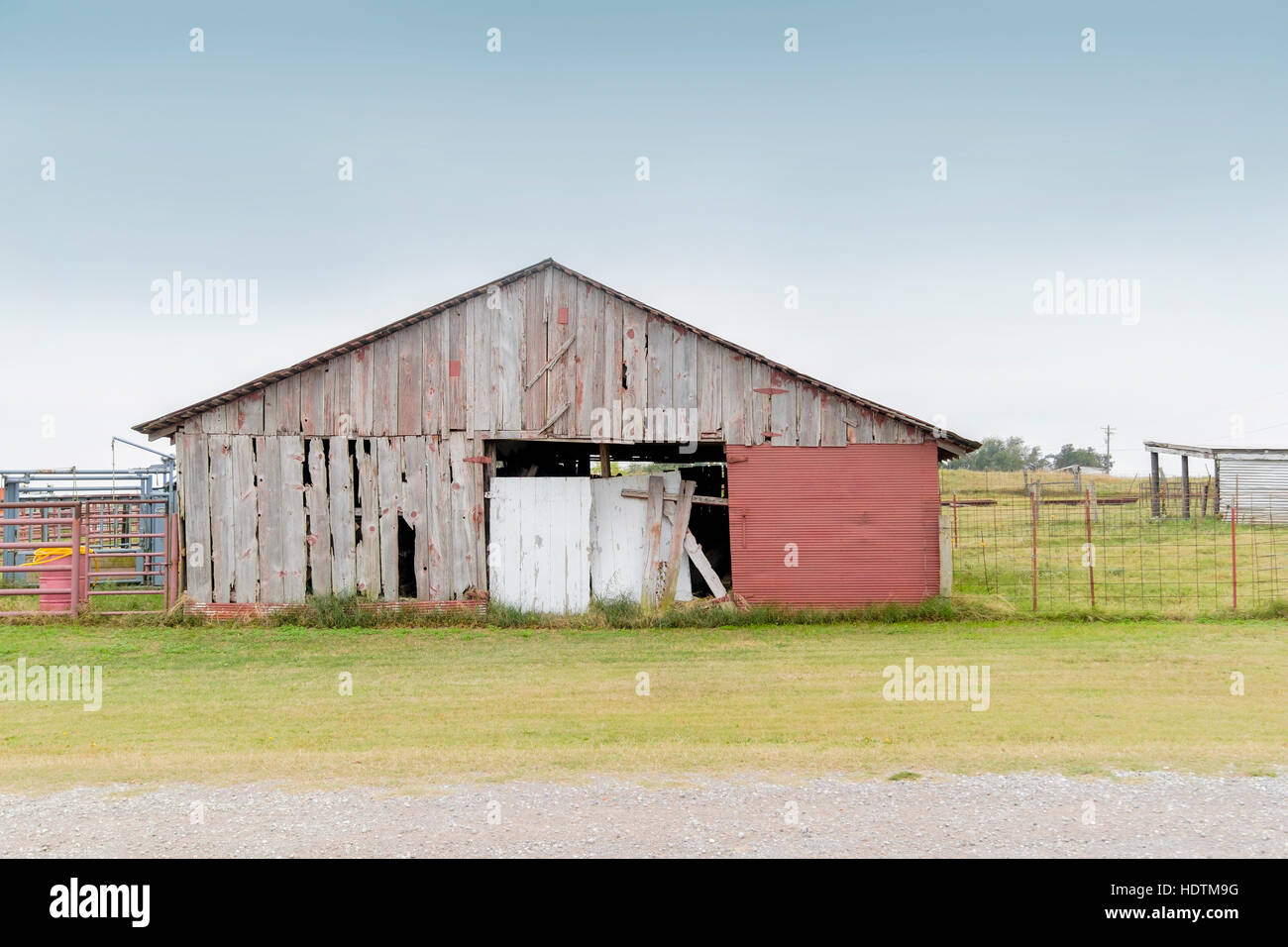An old dilapidated wooden barn falling apart on a farm in the ...