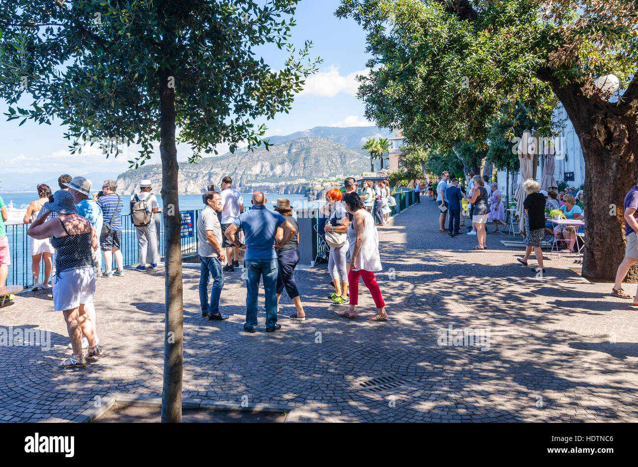 Tourists at the sea front in Villa Comunale Park, Sorrento, Italy ...