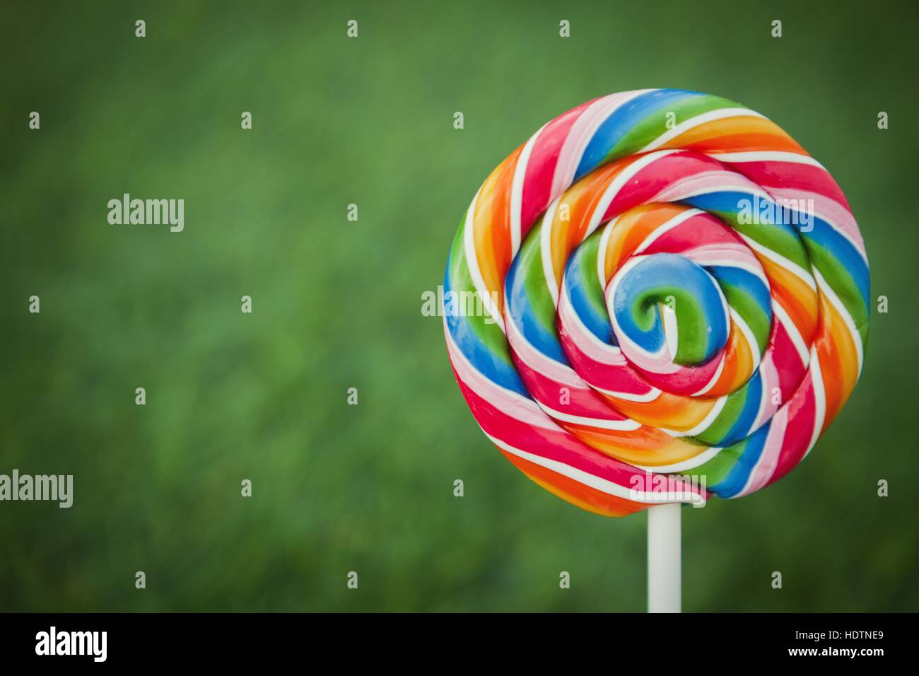 Nice round lollipop with many colors in a spiral Stock Photo - Alamy