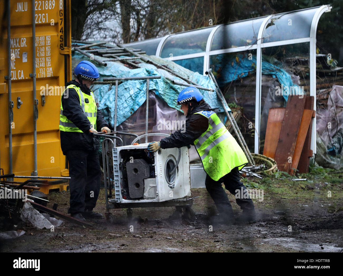 Police remove contents as they search a cottage and its grounds where ...