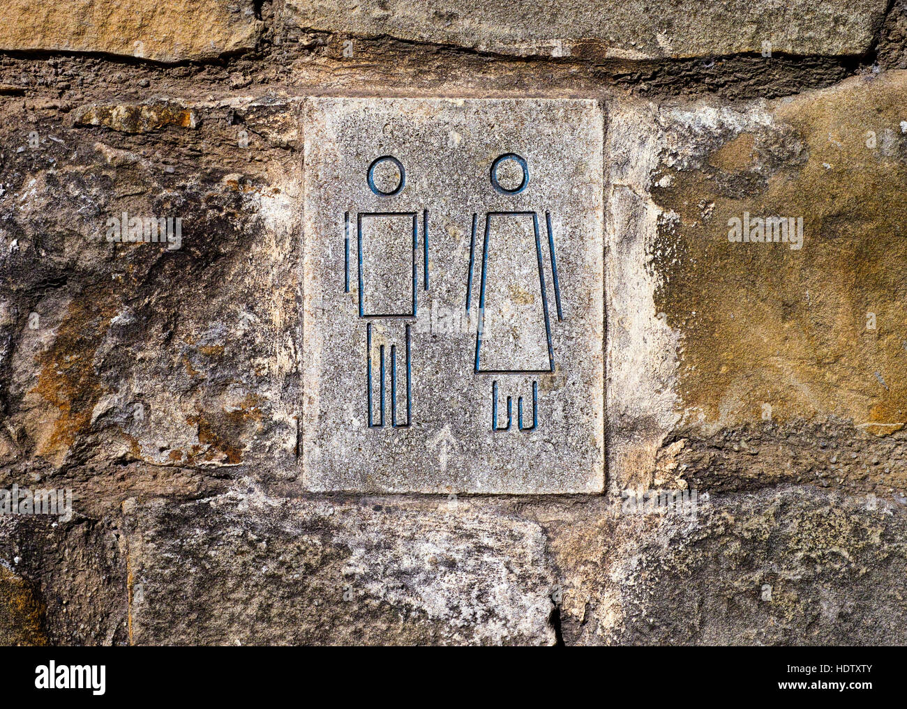Man and woman symbols on stone wall. Close-up Stock Photo - Alamy