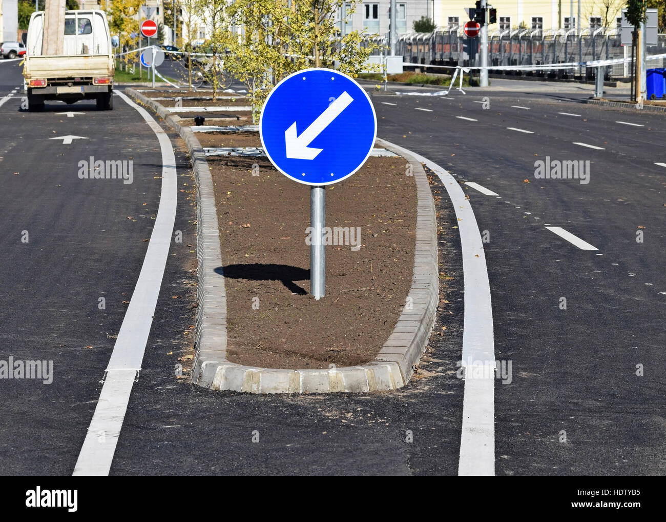 Arrow sign at the road crossing in the city Stock Photo - Alamy