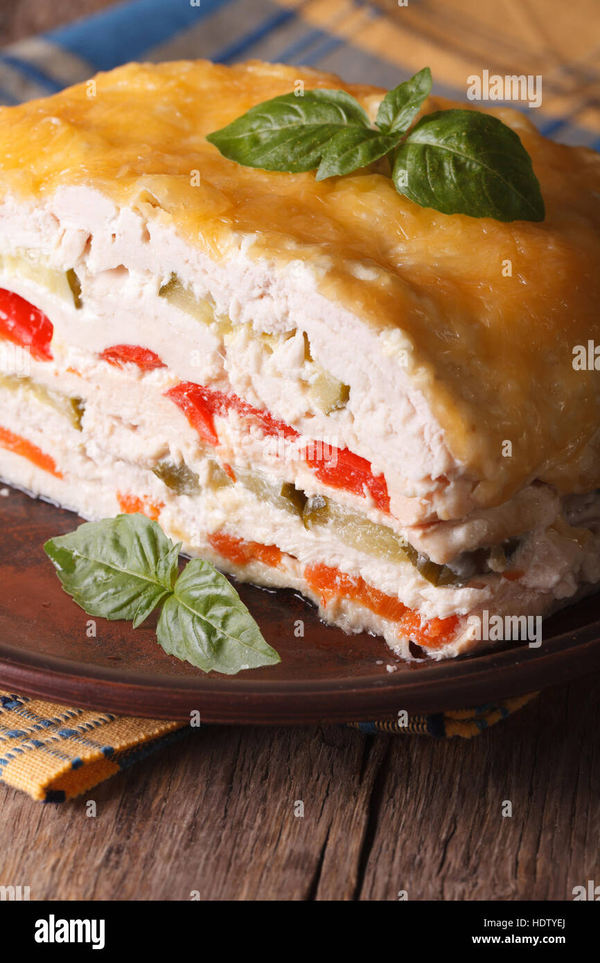 Cut chicken pie with vegetables and cheese on a plate macro. Vertical ...