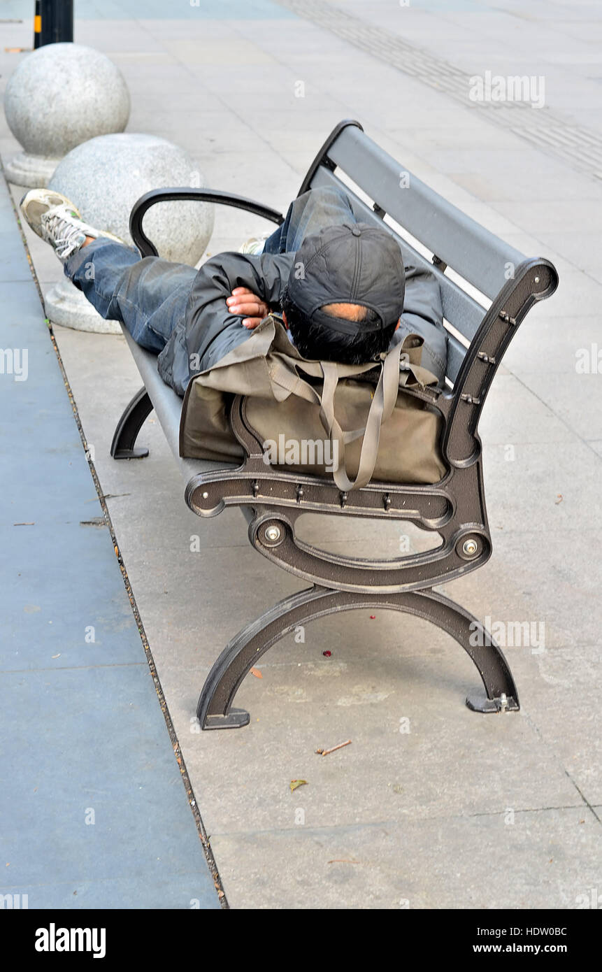 A poor man taking rest on bench Stock Photo - Alamy