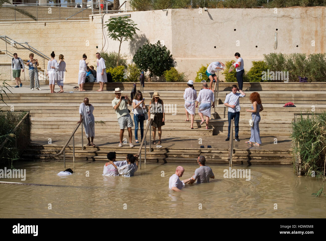 Religious Christians immerse themselves into the waters of the Jordan ...