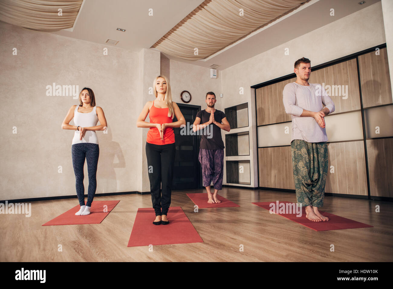 group of smiling people with trainer exercising in the gym Stock Photo ...