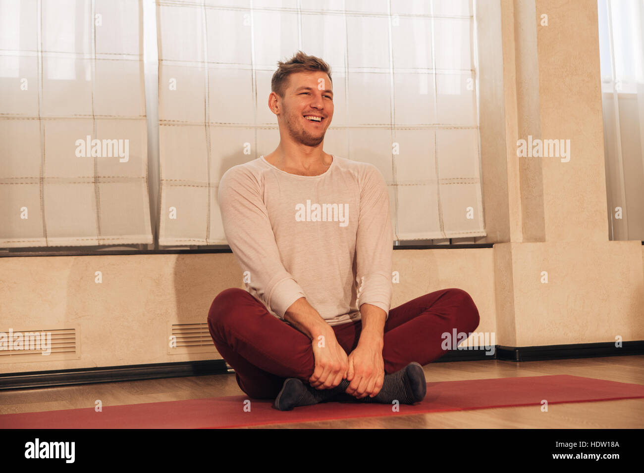 the man in the Lotus position and smiling Stock Photo - Alamy