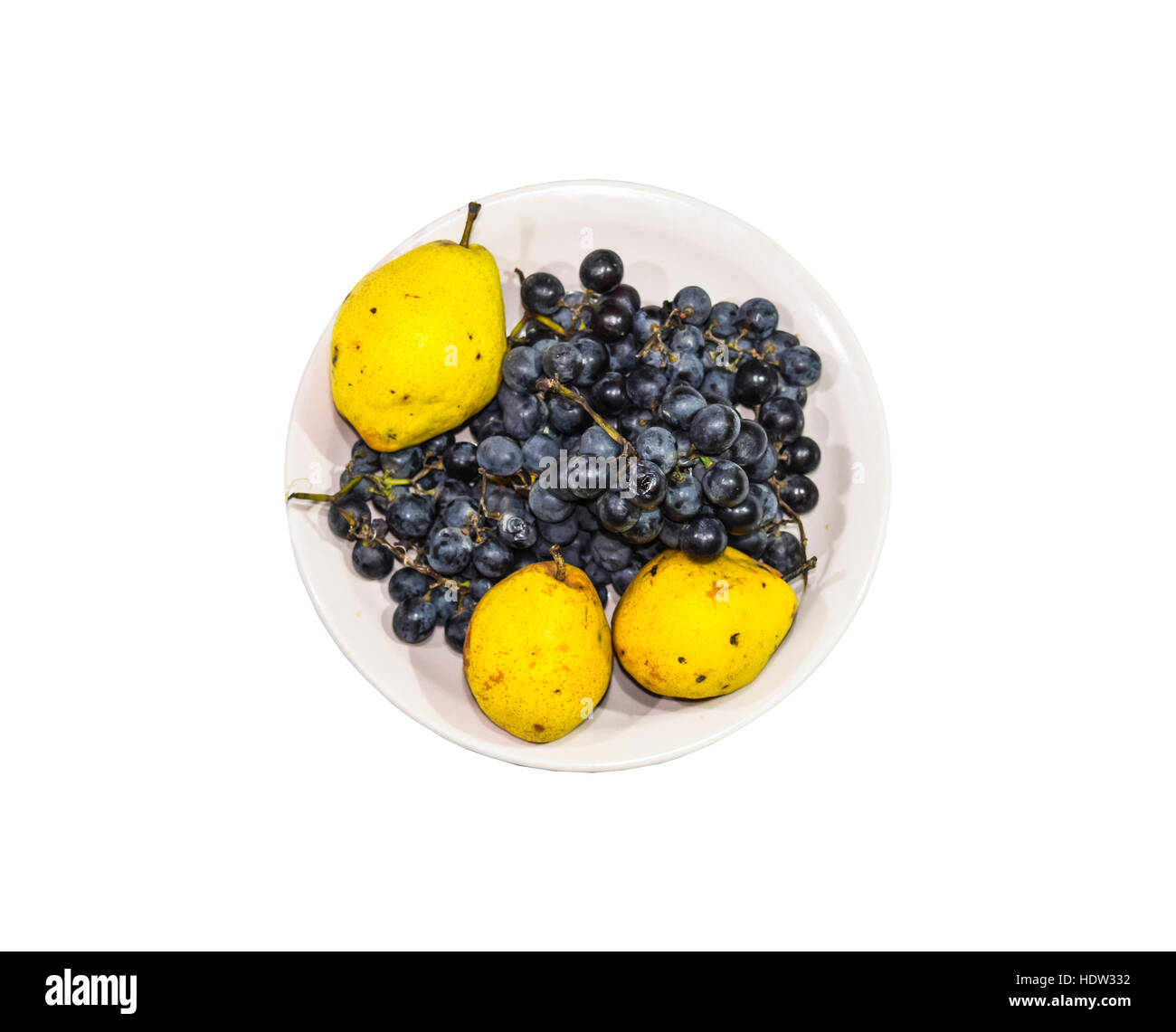 Yellow pear and grapes on the plate Stock Photo - Alamy