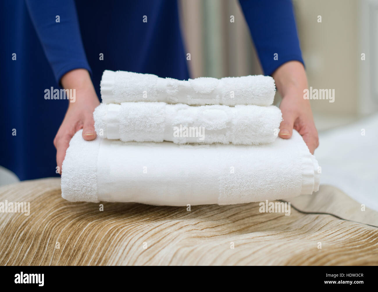 Room service. Woman changing towels in hotel room Stock Photo - Alamy