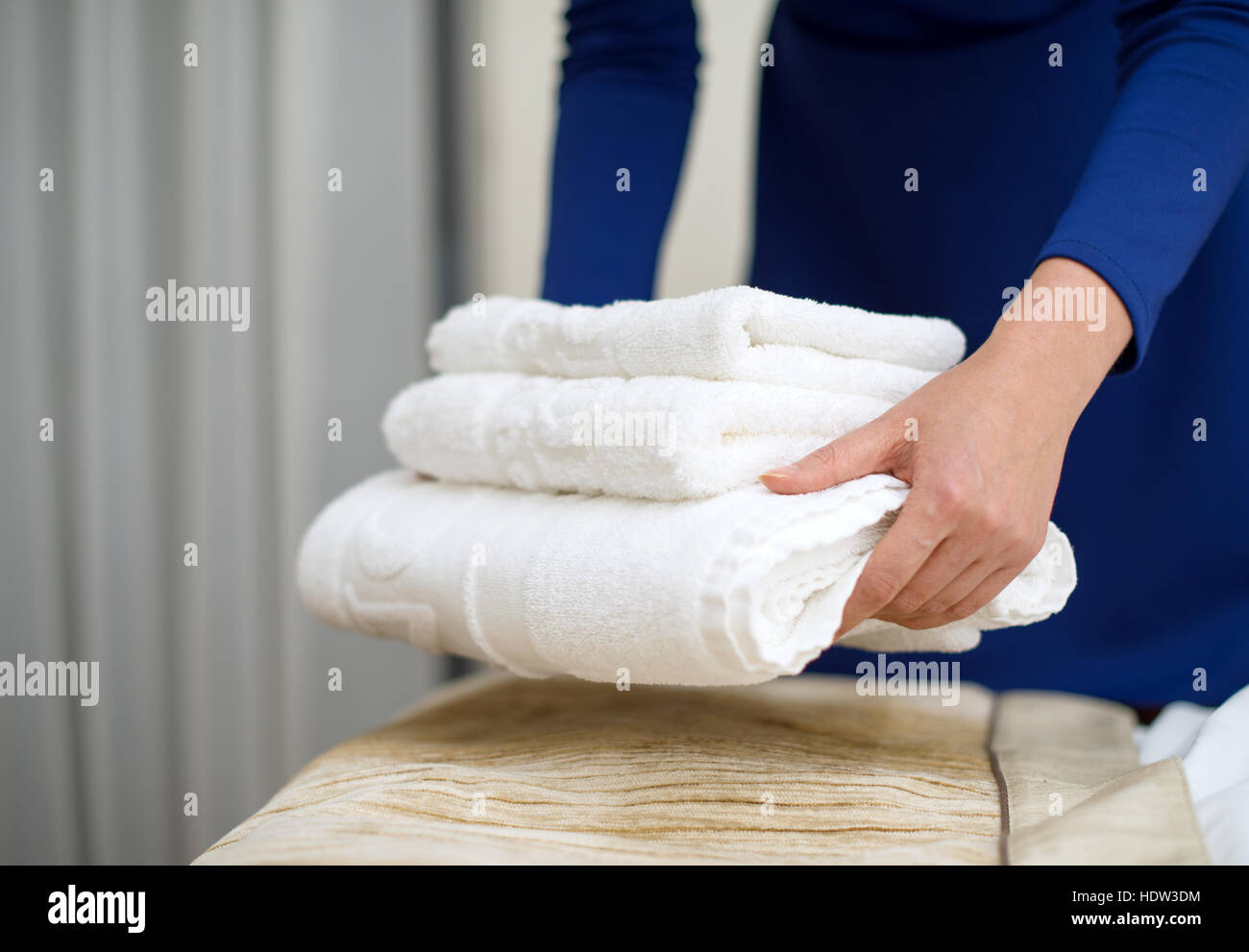 Room service. Woman changing towels in hotel room Stock Photo - Alamy