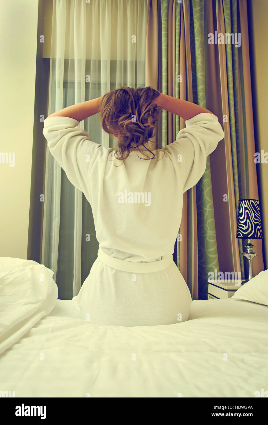Woman waking up in her bed. Back view Stock Photo - Alamy