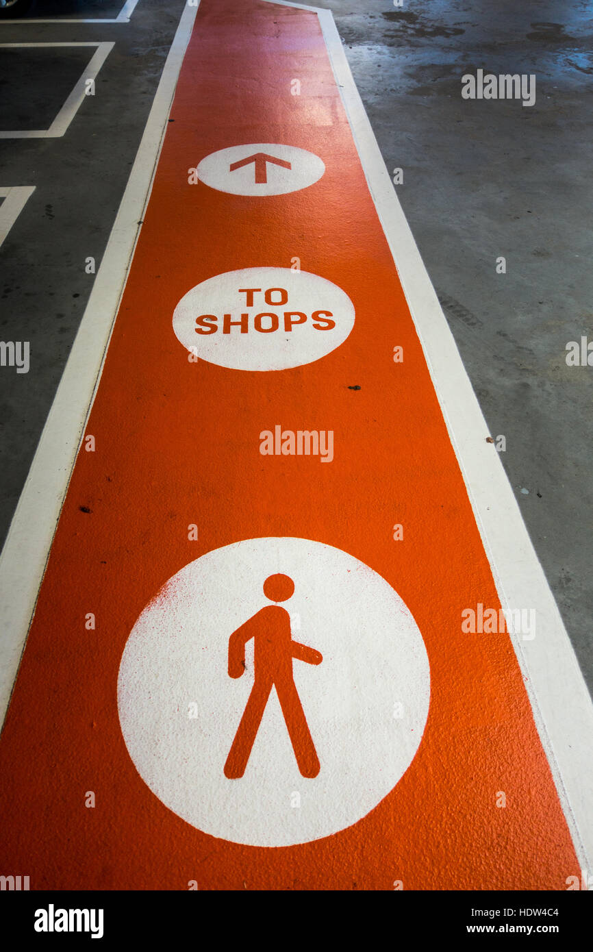 An orange painted pathway for pedestrians to shops Stock Photo - Alamy