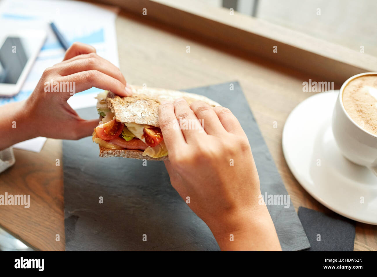 woman eating salmon panini sandwich at restaurant Stock Photo - Alamy