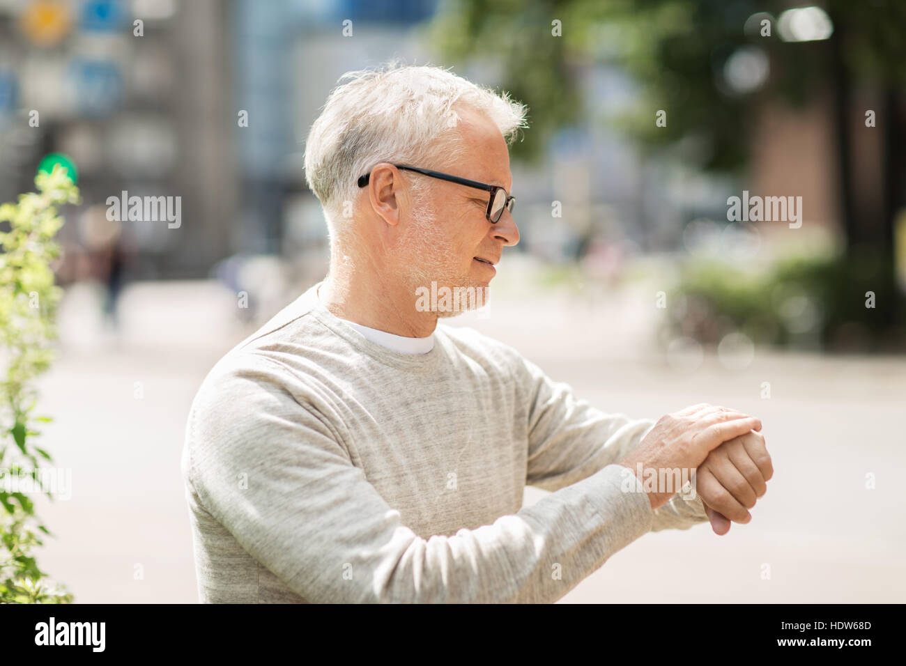 senior man checking time on his wristwatch Stock Photo - Alamy