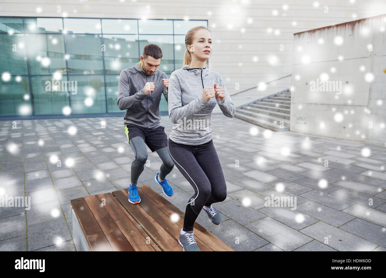 couple of sportsmen making step exercise on bench Stock Photo - Alamy