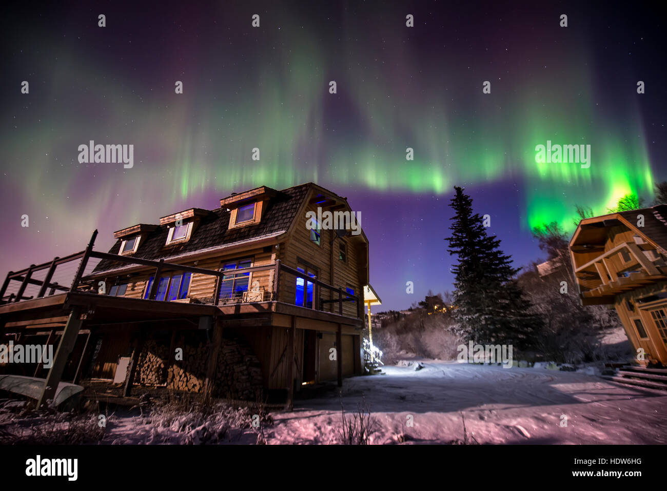 Aurora borealis over a home on the Anchorage hillside, Southcentral ...