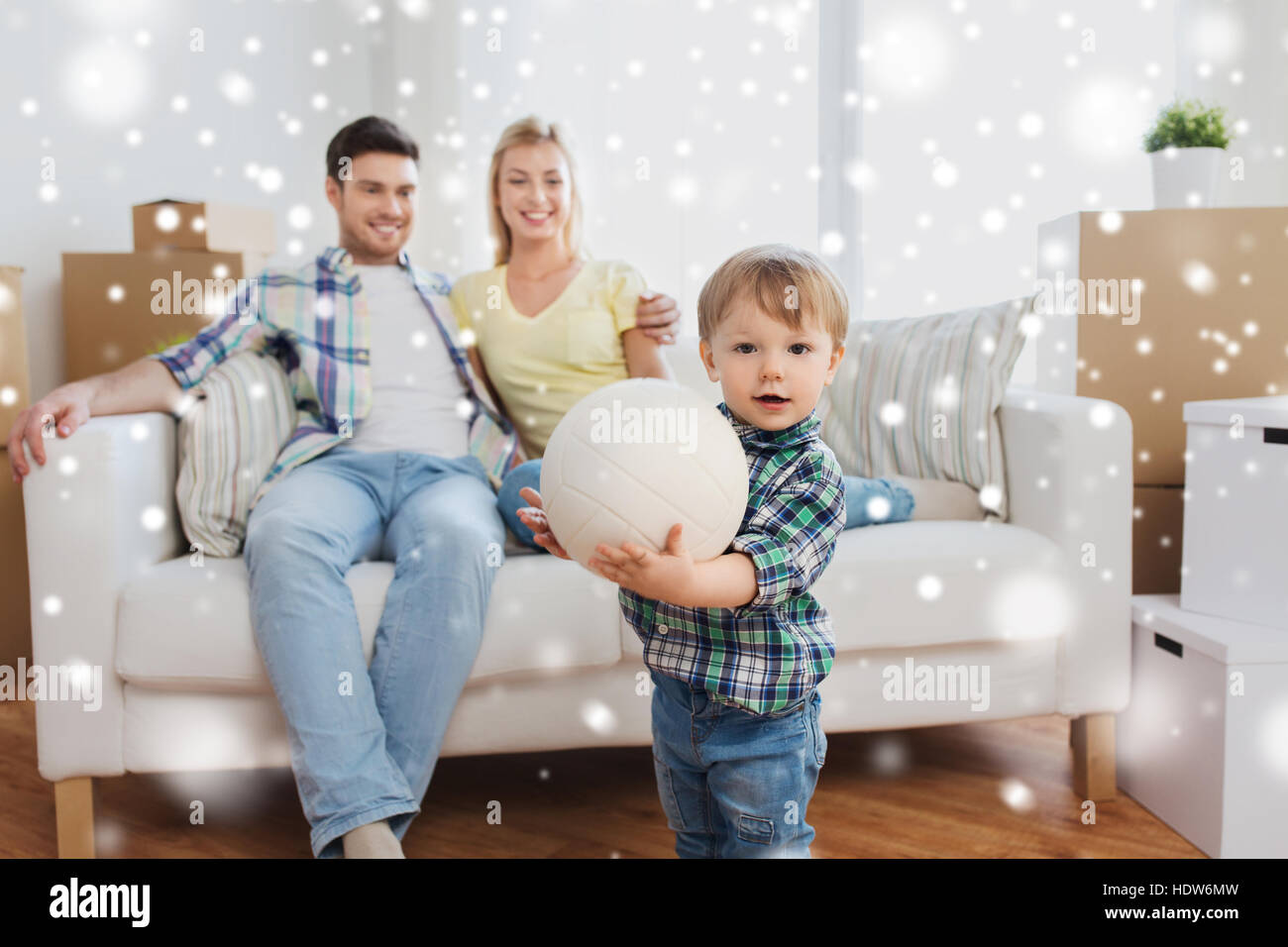 happy little boy with ball over parents at home Stock Photo - Alamy