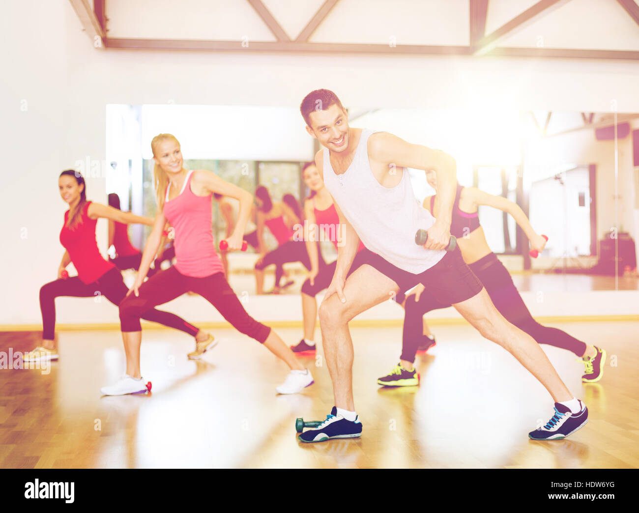 group of smiling people working out with dumbbells Stock Photo - Alamy