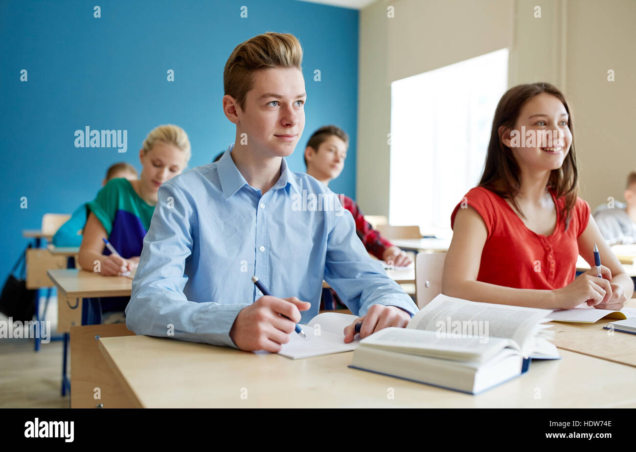 group of students with books at school lesson Stock Photo - Alamy