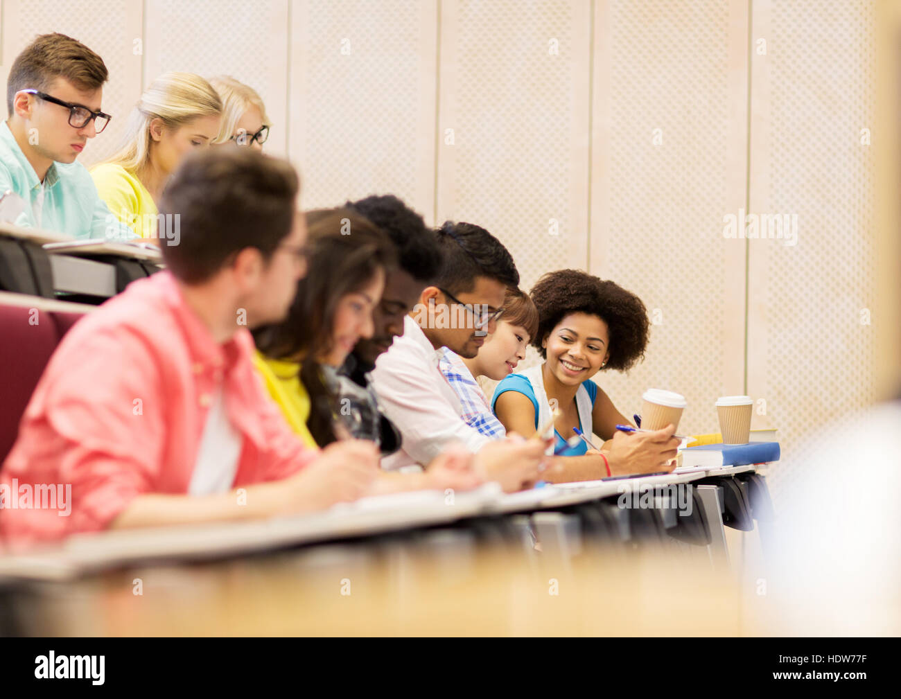 group of students with coffee writing on lecture Stock Photo - Alamy