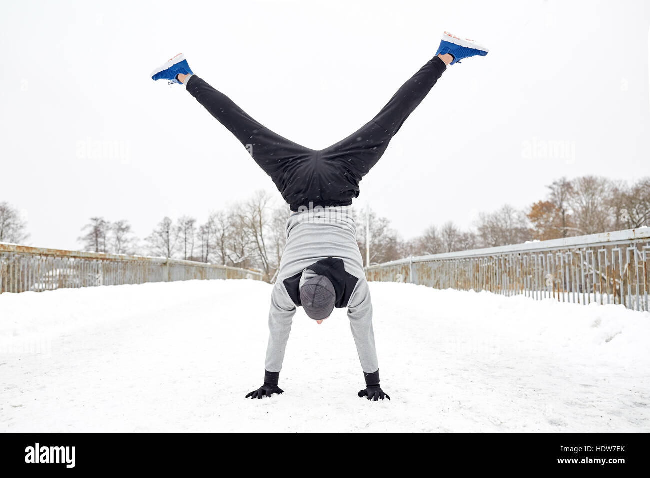 young man doing handstand in winter Stock Photo - Alamy
