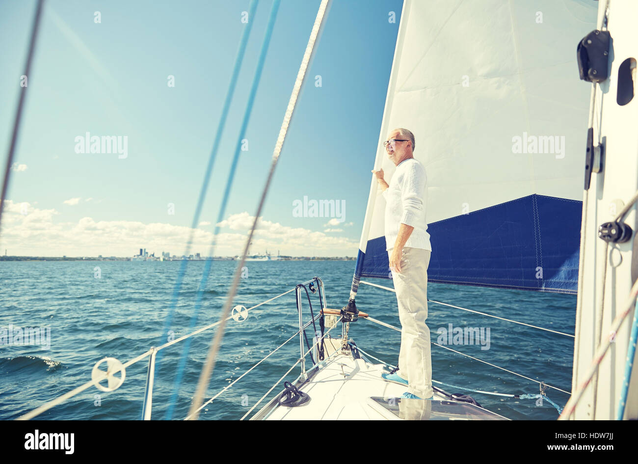 senior man on sail boat or yacht sailing in sea Stock Photo - Alamy
