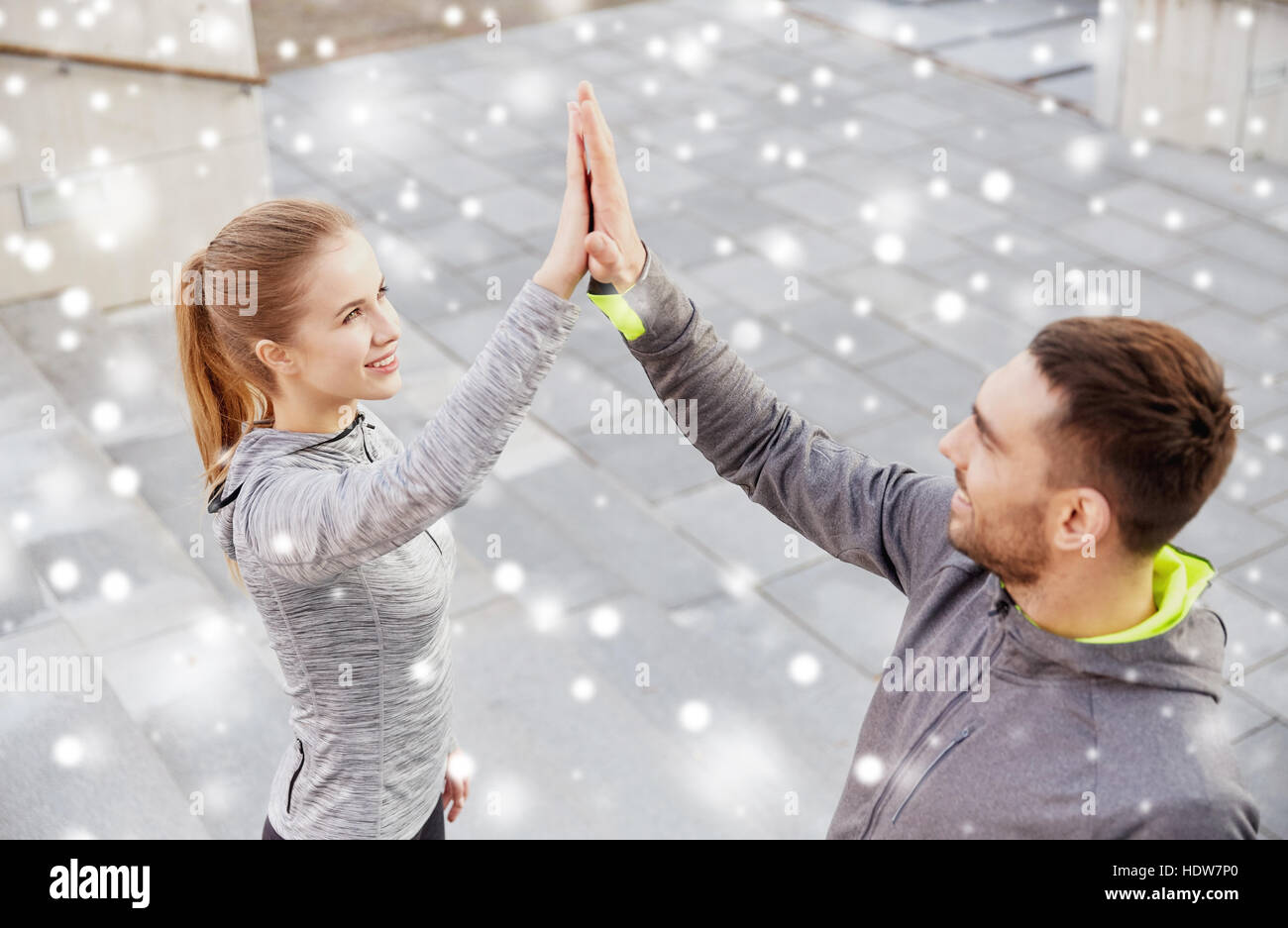 couple of sportsmen making high five outdoors Stock Photo - Alamy