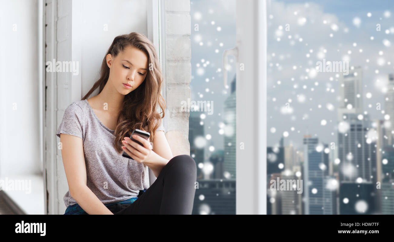 sad pretty teenage girl with smartphone texting Stock Photo - Alamy