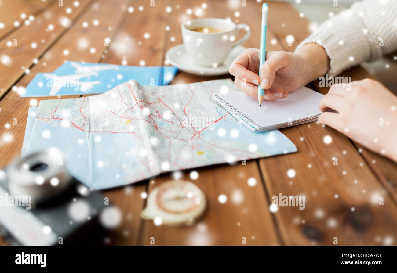hands with map and coffee writing to notebook Stock Photo - Alamy