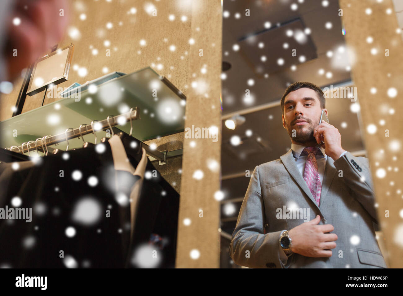man calling on smartphone at clothing store mirror Stock Photo - Alamy